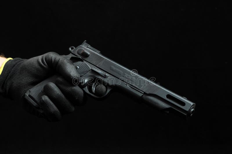 Gun and a Hand on a Black stock image. Image of crime - 33793109
