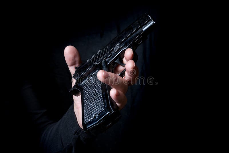 Gun in the hand of man stock photo. Image of criminal - 113674426