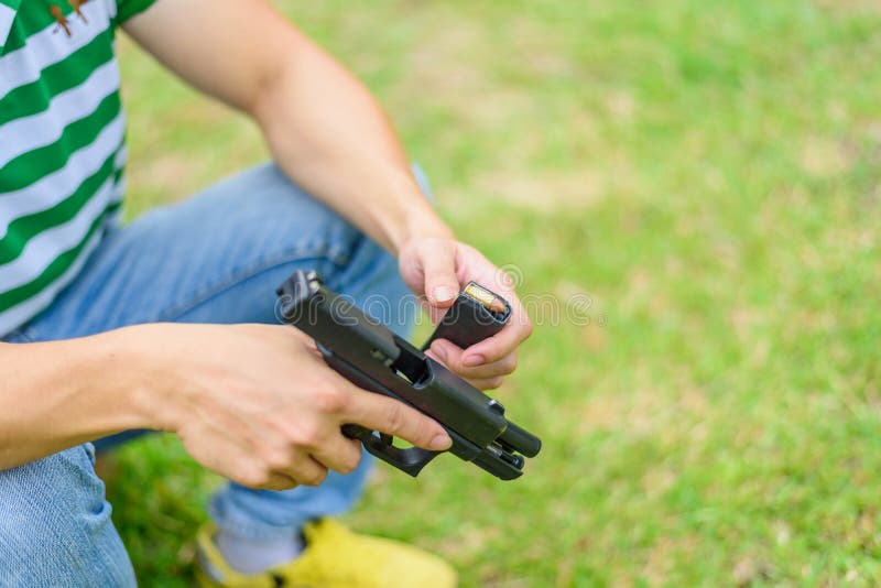 Gun Man Hand on Green Background Stock Image - Image of bullet, black ...