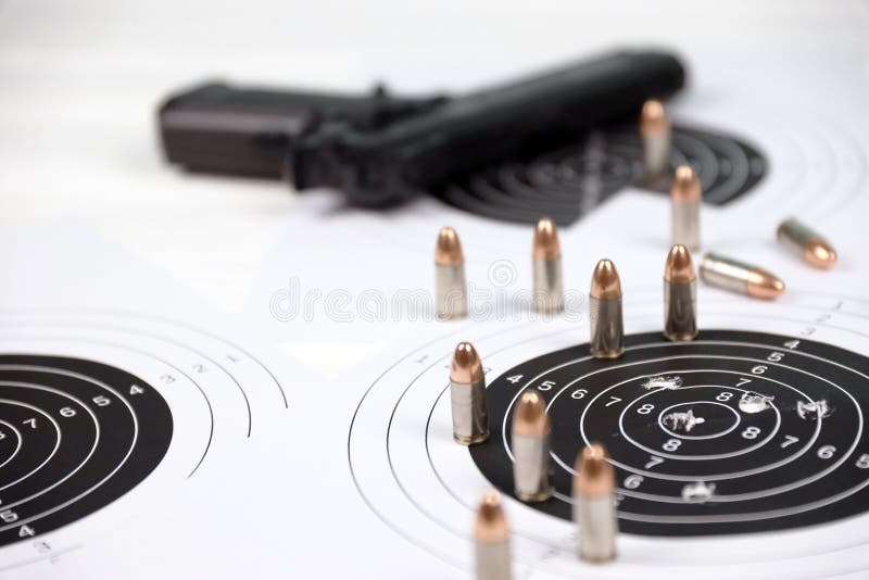 Gun and Many Bullets Shooting Targets on White Table in Shooting Range ...