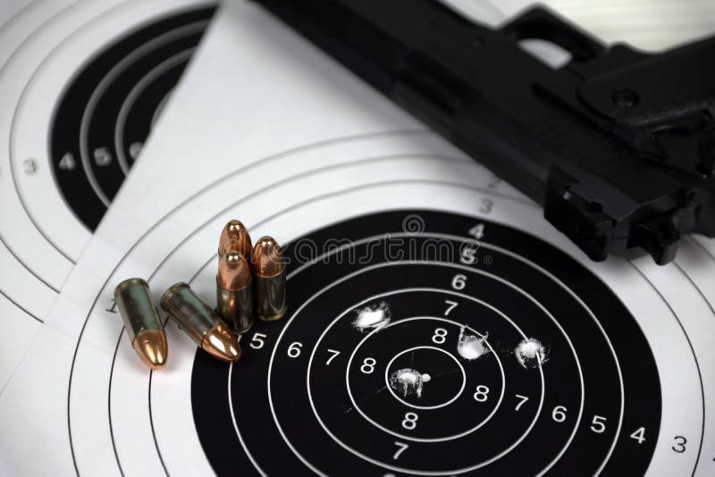 Gun and Many Bullets Shooting Targets on White Table in Shooting Range ...