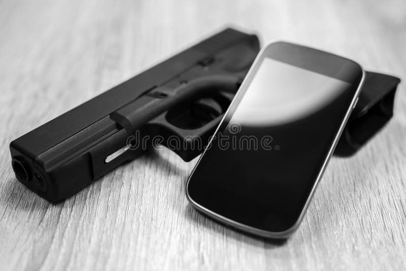 A Gun and a Modern Smart Phone, Black and White Stock Photo - Image of ...
