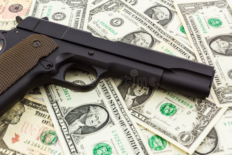 Gun on money background. stock photo. Image of business - 51570904