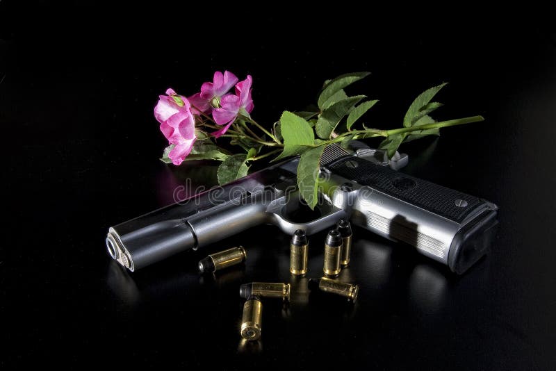 The gun & roses stock photo. Image of pistol, automatic - 10366630