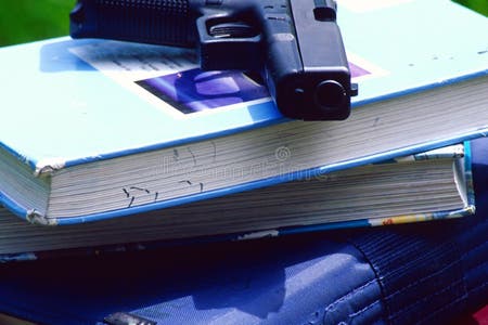 Gun on school books stock photo. Image of fear, danger - 4949710