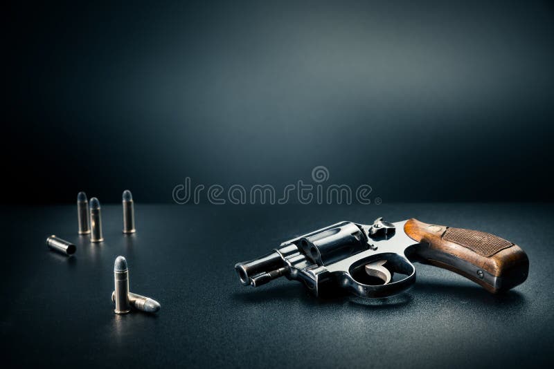 Gun Sitting on a Table with Bullet Shells / Dramatic Lighting Stock ...