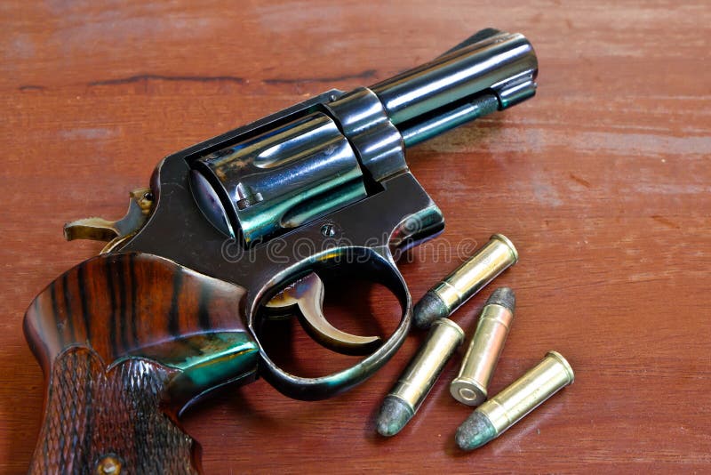 Revolver with Bullets on the Table Stock Photo - Image of holding ...