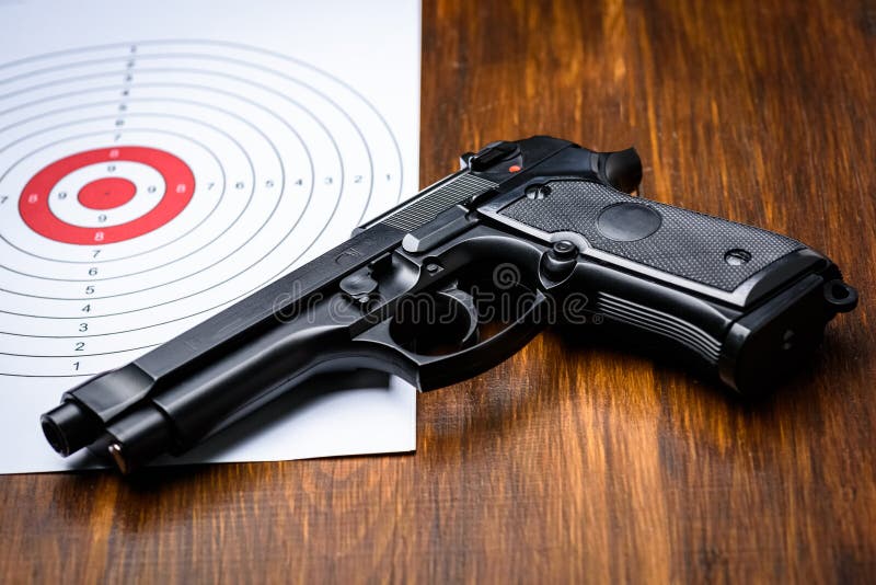 Gun & shield stock photo. Image of metal, firearm - 218654924
