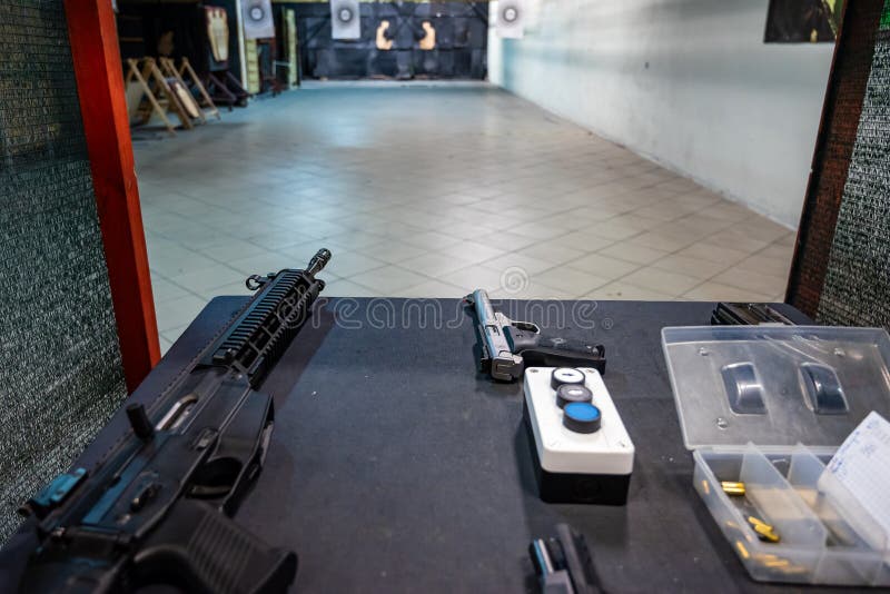 Guns, Rifle, Pistols and Bullets on the Table at a Shooting Range Stock ...
