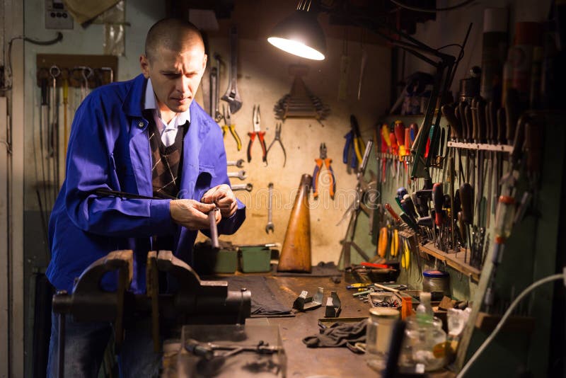 Gunsmith Assembling Shotgun after Diagnostics and Repair in Weapons ...