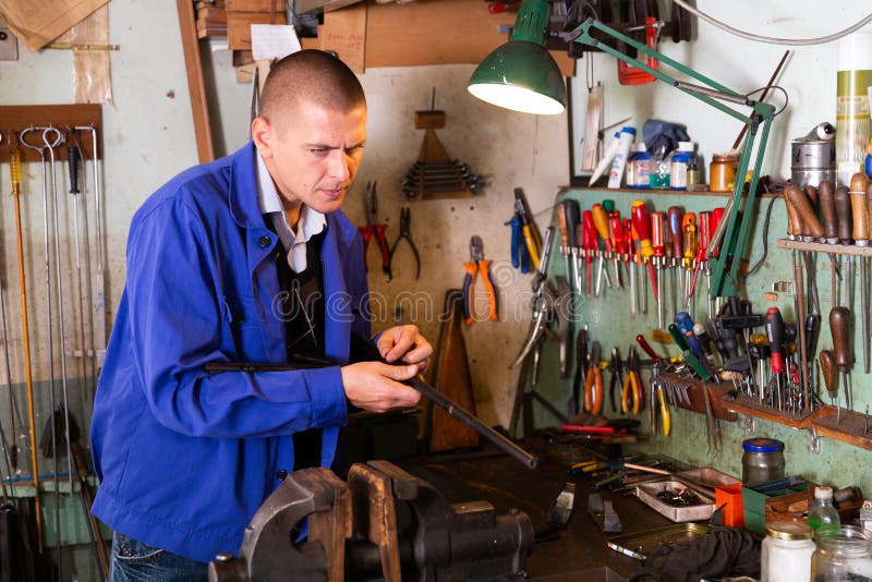 Gunsmith Assembling Shotgun after Diagnostics and Repair in Weapons ...