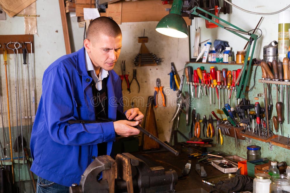 Gunsmith Assembling Shotgun after Diagnostics and Repair in Weapons ...