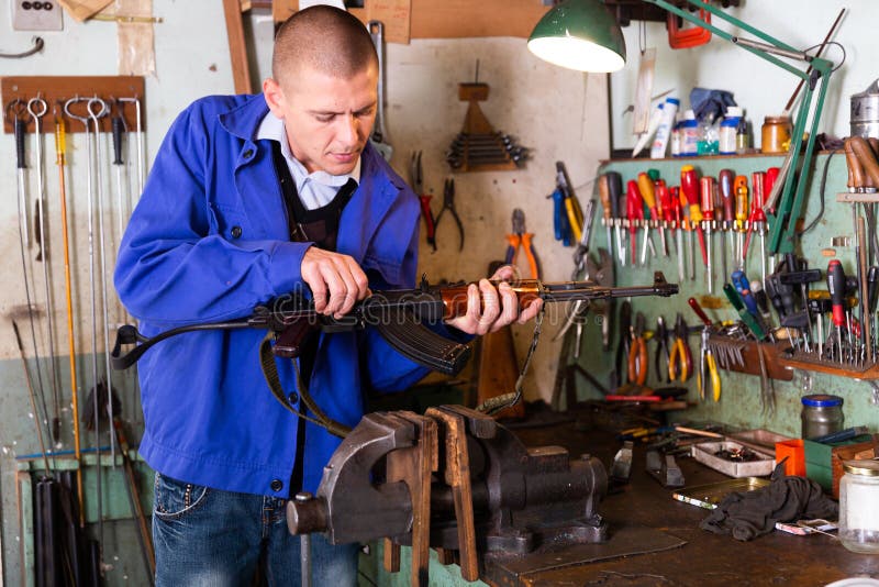 Gunsmith with Kalashnikov Assault Rifle in Weapons Workshop Stock Image ...
