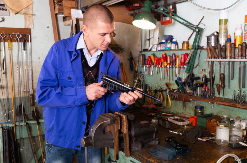 Gunsmith Disassembles and Repairs Pistol in Weapons Workshop Stock ...