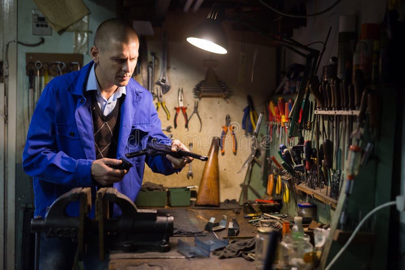 Gunsmith Disassembles and Repairs Pistol in Weapons Workshop Stock ...