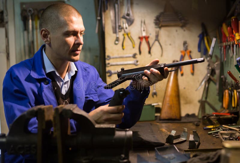Gunsmith Disassembles and Repairs Pistol in Weapons Workshop Stock ...