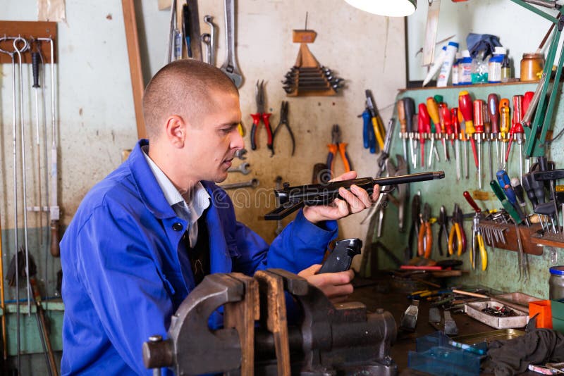 Gunsmith Disassembles and Repairs Pistol in Weapons Workshop Stock ...