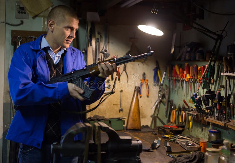 Gunsmith with Kalashnikov Assault Rifle in Weapons Workshop Stock Photo ...