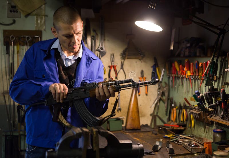Gunsmith with Kalashnikov Assault Rifle in Weapons Workshop Stock Photo ...