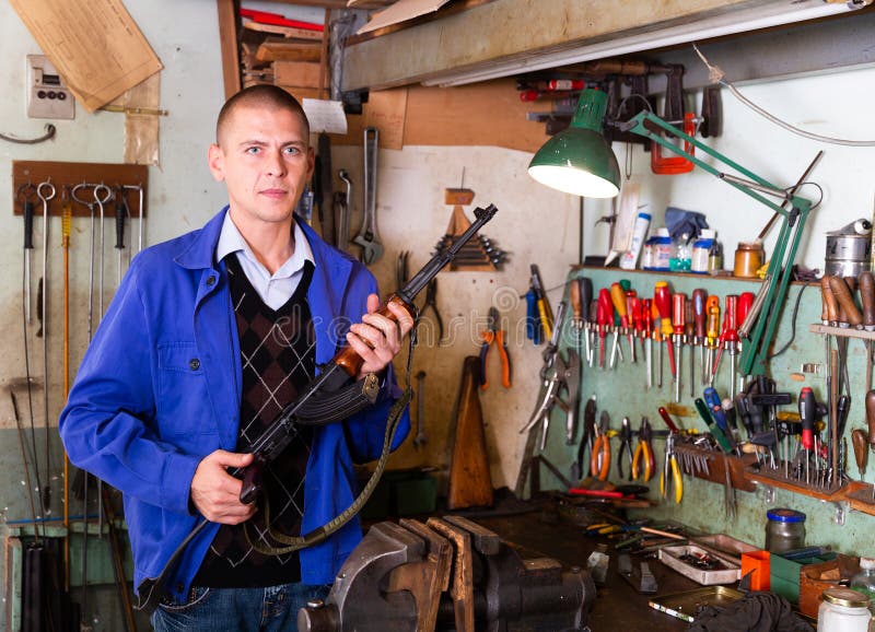 Gunsmith with Kalashnikov Assault Rifle in Weapons Workshop Stock Image ...