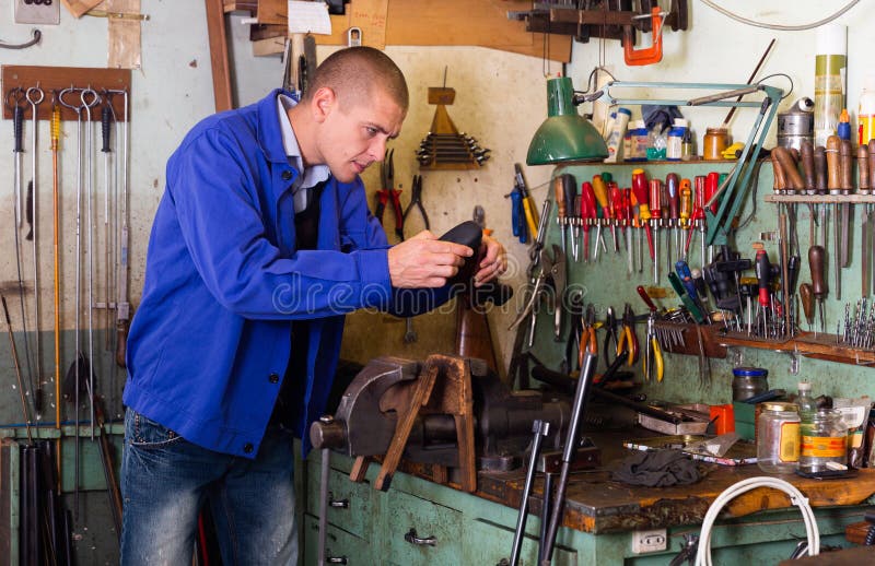 Gunsmith Repairs of a Shotgun in Weapons Workshop Stock Image - Image ...