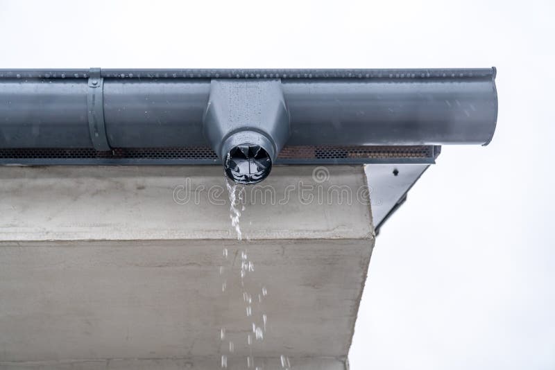 Gutter with Flowing Rainwater on the Roof of the Building Stock Image ...