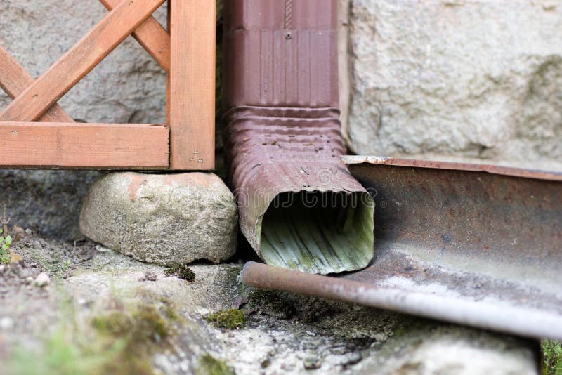 A Gutter Mounted on the Wall of the Building. Gutter Spout in Si Stock ...