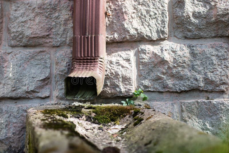 A Gutter Mounted on the Wall of the Building. Gutter Spout in Si Stock ...