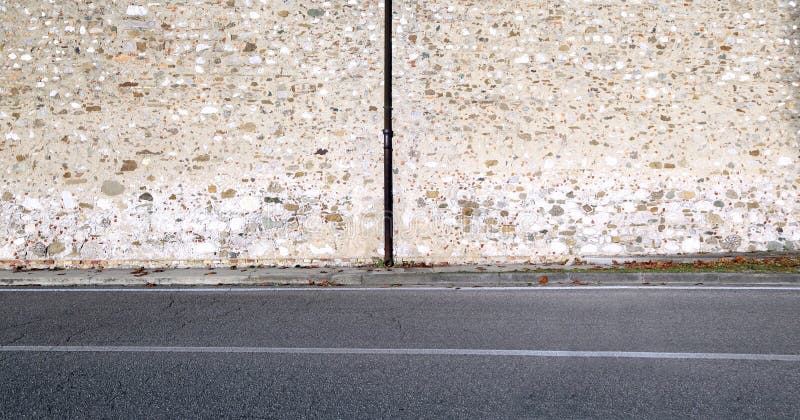 Gutter on Old High Stone Wall. Cement Sidewalk and Street in Front ...