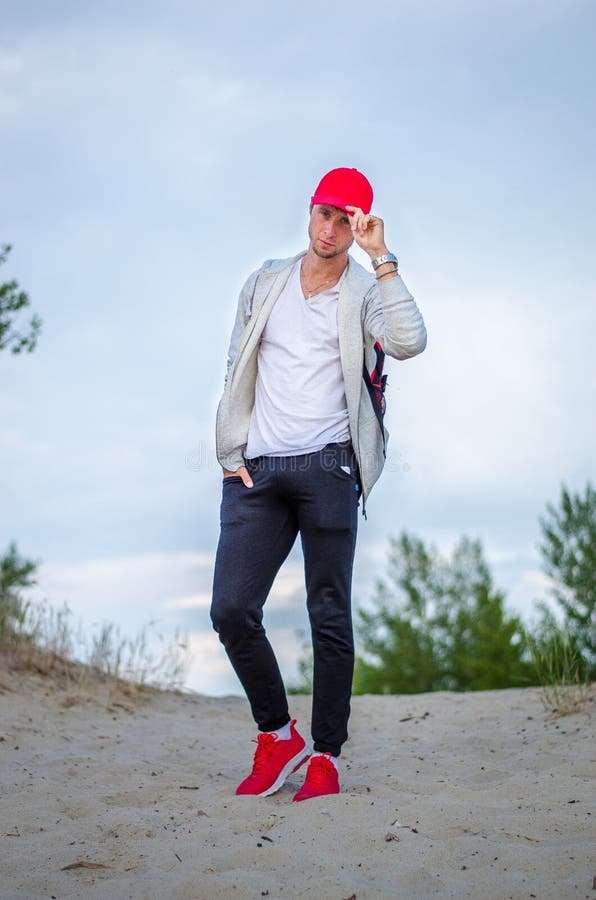 The guy adjusts the cap stock photo. Image of blue, park - 98579836