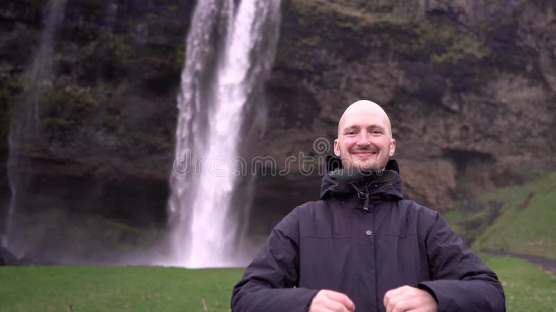 Guy Against the Backdrop of a Waterfall in Iceland Stock Video - Video ...