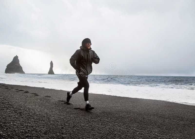 Guy Athlete Runs on a Black Beach in Iceland Stock Image - Image of ...