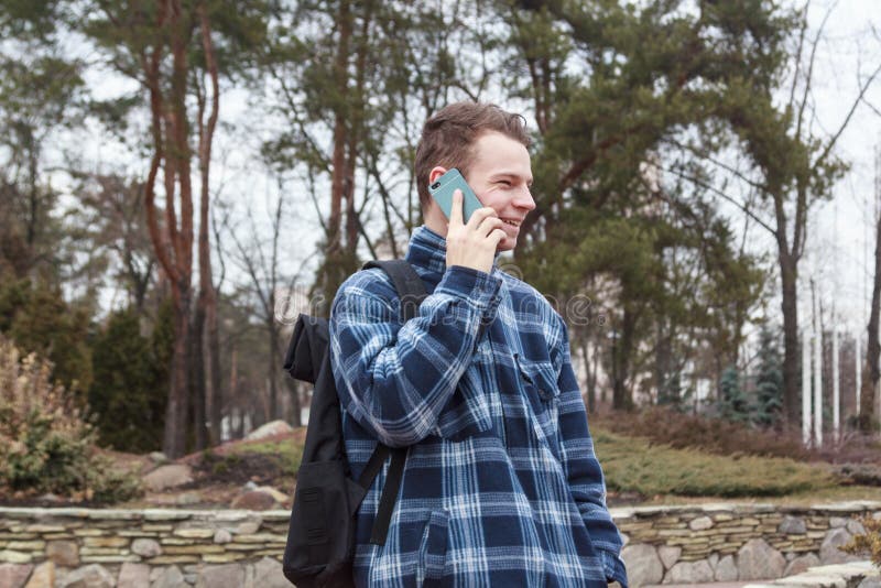 Guy with a Backpack Talking on the Phone Stock Photo - Image of ...