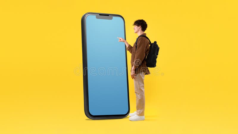 Guy with Backpack Using Giant Phone with Empty Screen, Studio Stock ...