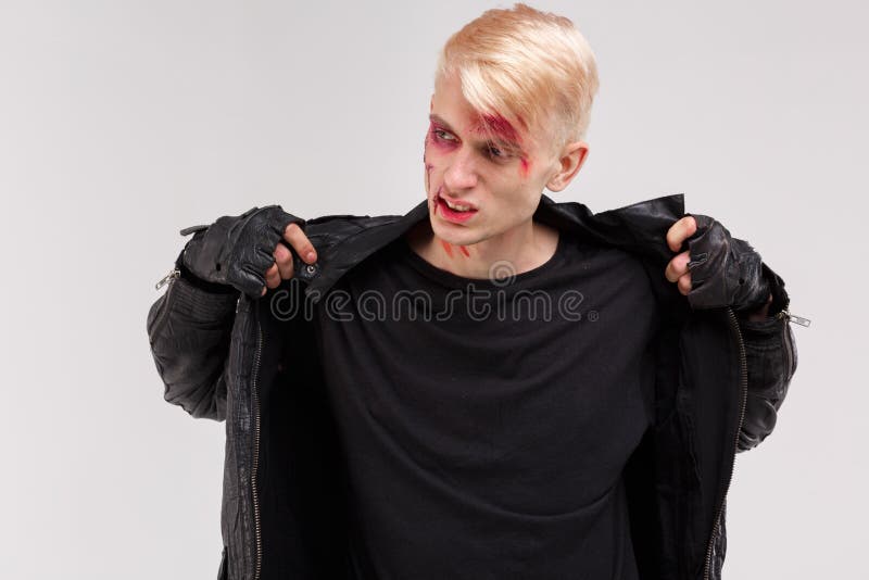 A Guy with a Battered Face Screams His Face in Pain and Puts on Jacket ...