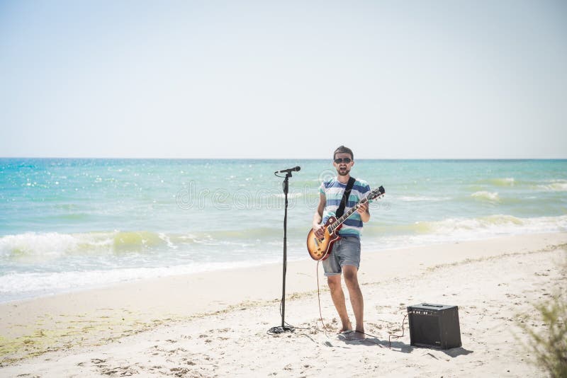 The Guy on the Beach with Musical Instruments Stock Image - Image of ...
