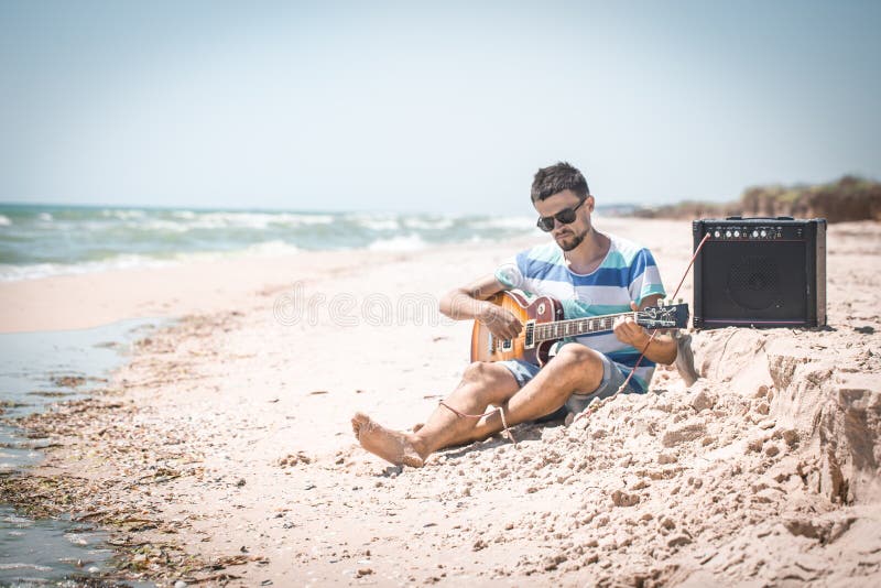 The Guy on the Beach with Musical Instruments Stock Image - Image of ...