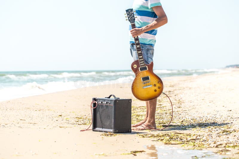 The Guy on the Beach with Musical Instruments Stock Photo - Image of ...