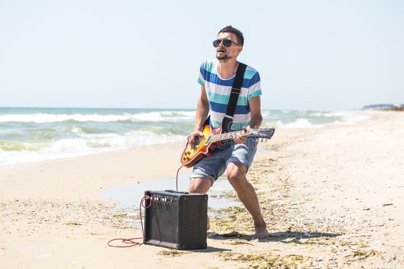 The Guy on the Beach with Musical Instruments Stock Photo - Image of ...