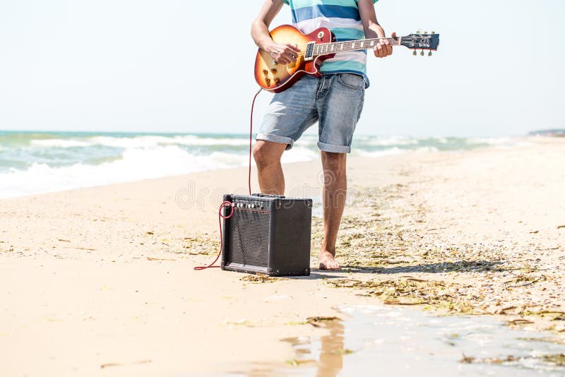 The Guy on the Beach with Musical Instruments Stock Photo - Image of ...