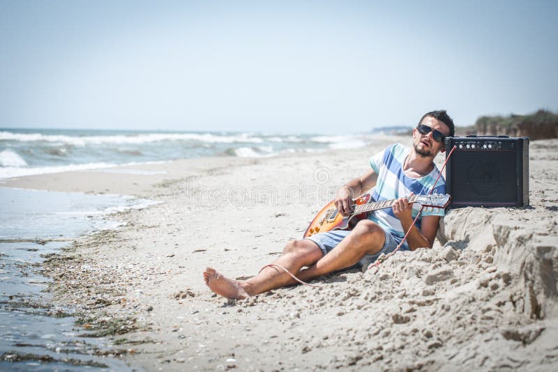 The Guy on the Beach with Musical Instruments Stock Image - Image of ...