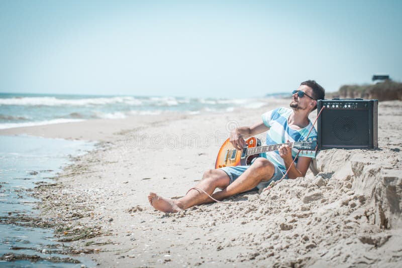 The Guy on the Beach with Musical Instruments Stock Image - Image of ...
