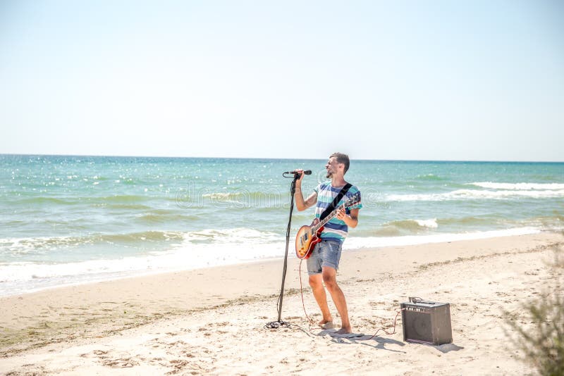 The Guy on the Beach with Musical Instruments Stock Image - Image of ...