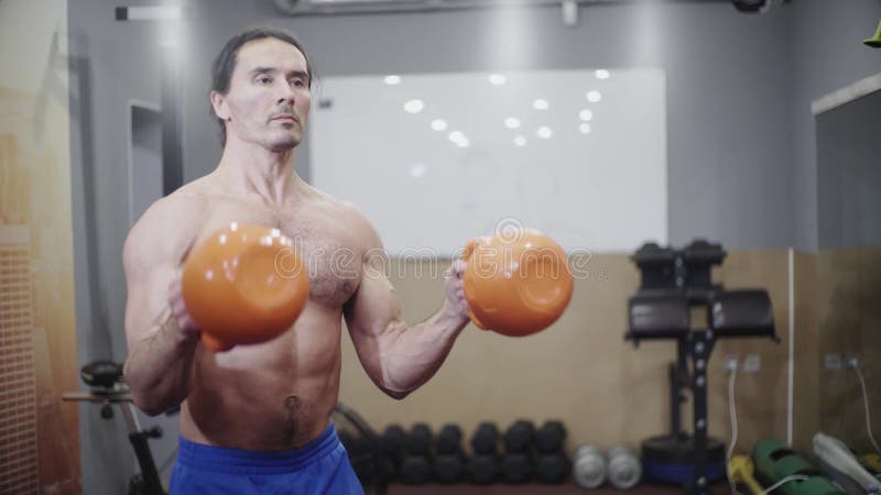 Guy, with Beautiful Muscles, Bodybuilder, Trains Biceps and Shoulder ...