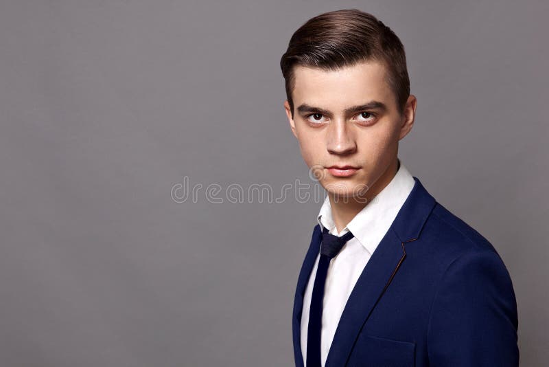 Guy in a Blue Jacket and Tie on a Gray Background in the Studio Stock ...