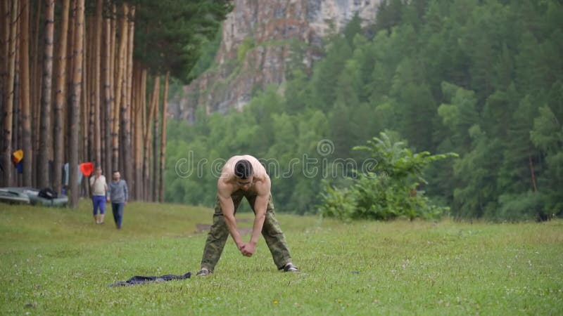 Guy Bodybuilder Doing Morning Exercises on a Hike. Stock Video - Video ...