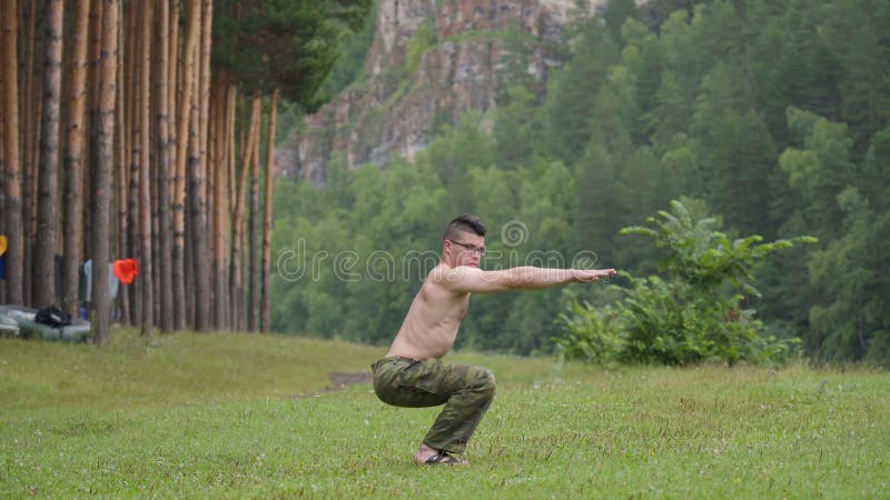 Guy Bodybuilder Doing Morning Exercises on a Hike. Stock Video - Video ...