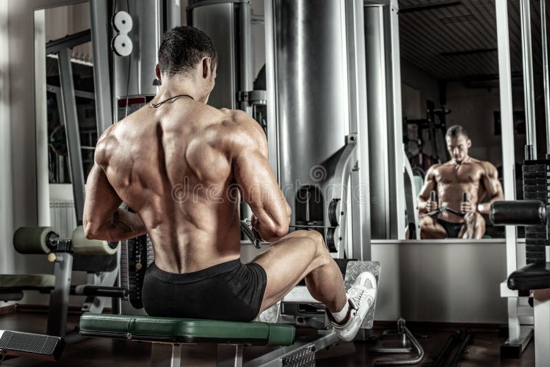 Guy Bodybuilder with Exercise Machine Stock Photo - Image of machine ...