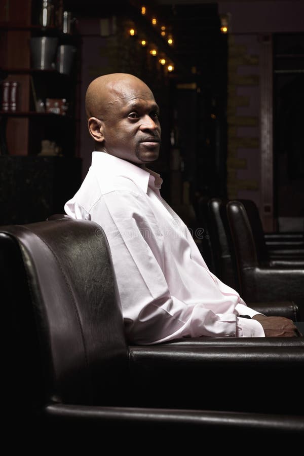 Guy in chair stock photo. Image of darkness, looking - 54999178