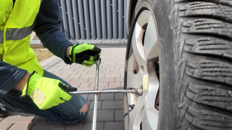 A Guy Changes Tire on Street To Summer Tire in Nature Stock Video ...